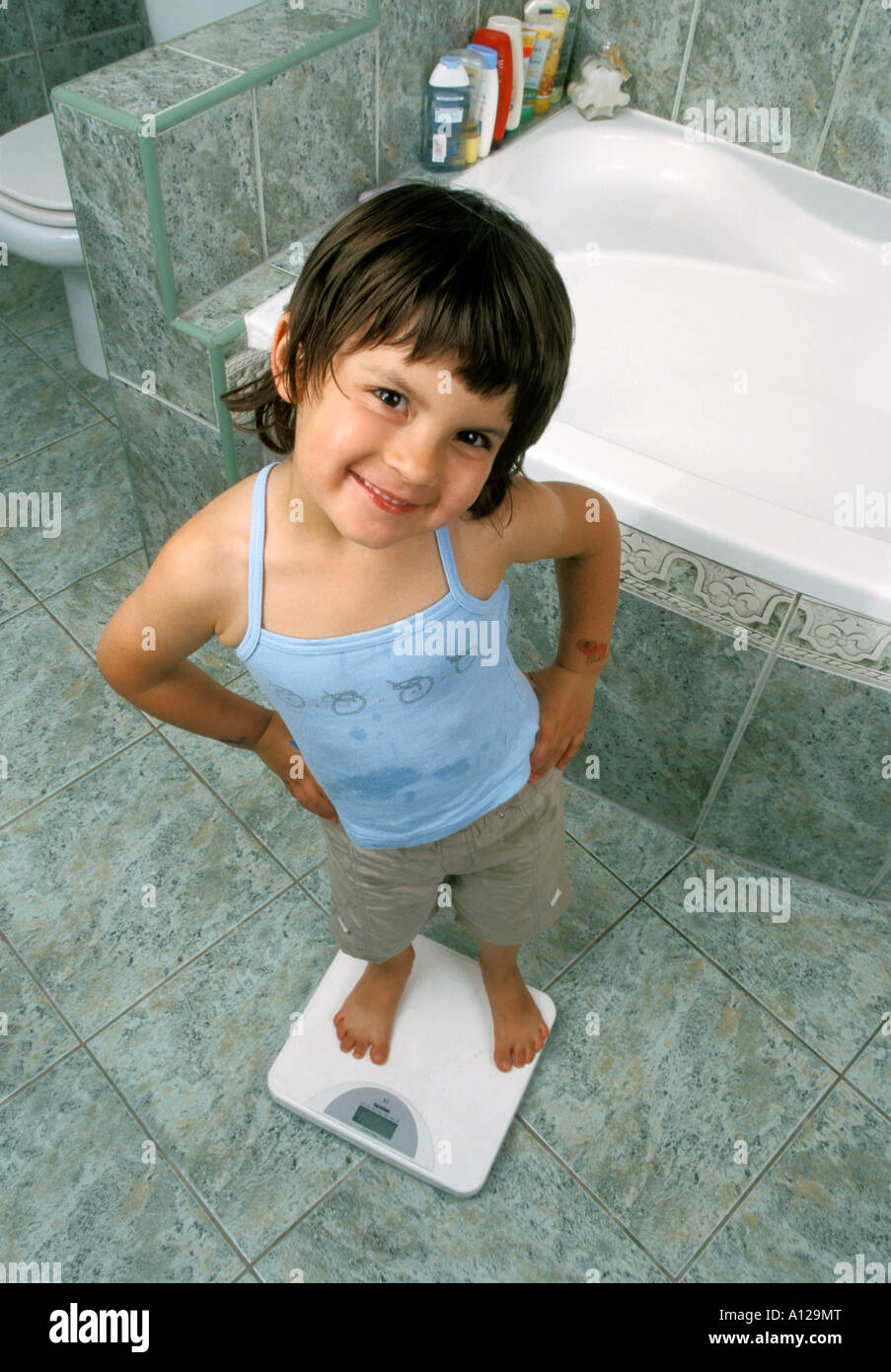 Girl checking weight Stock Photo - Alamy