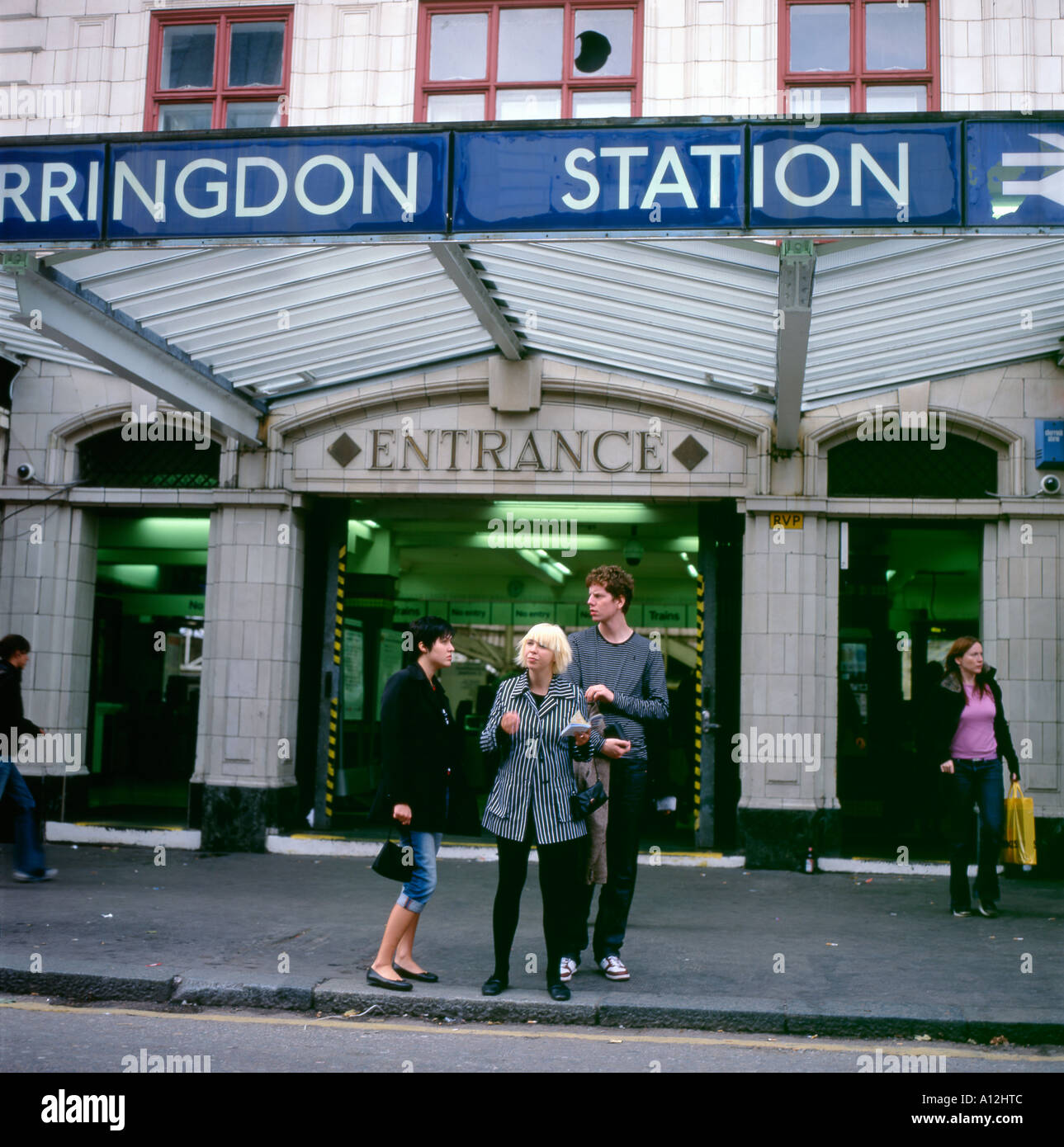 Young people standing outside Farringdon Rail Station entrance and sign ...