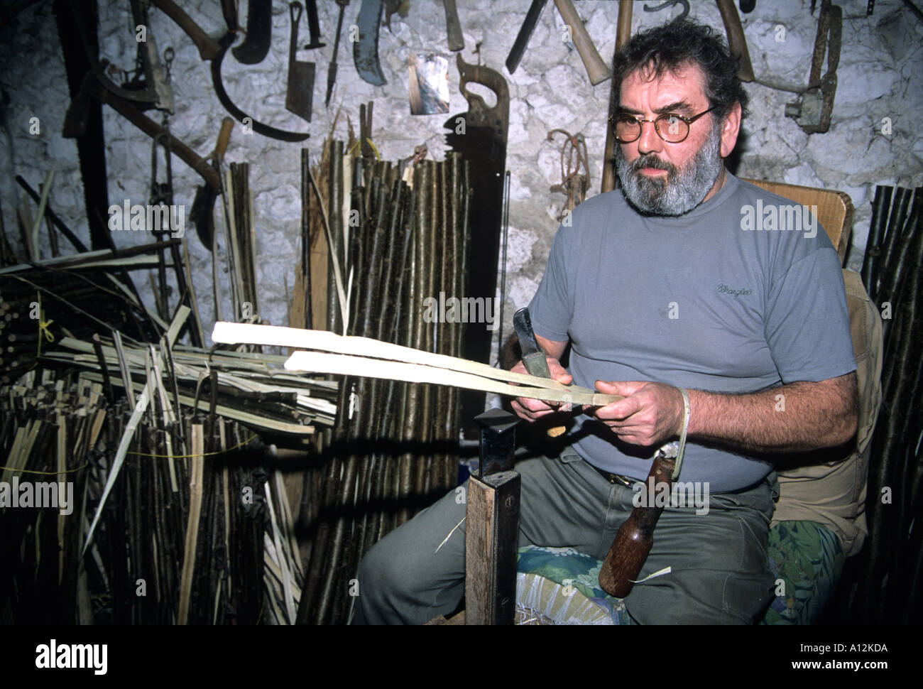 Making the traditional thatching spars from split hazel wood Stock ...