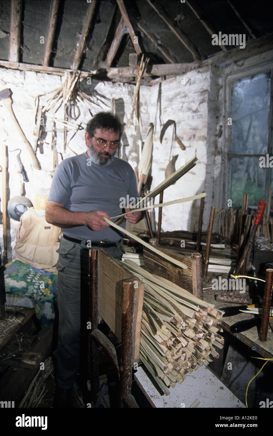 Making the traditional thatching spars from split hazel wood Stock ...