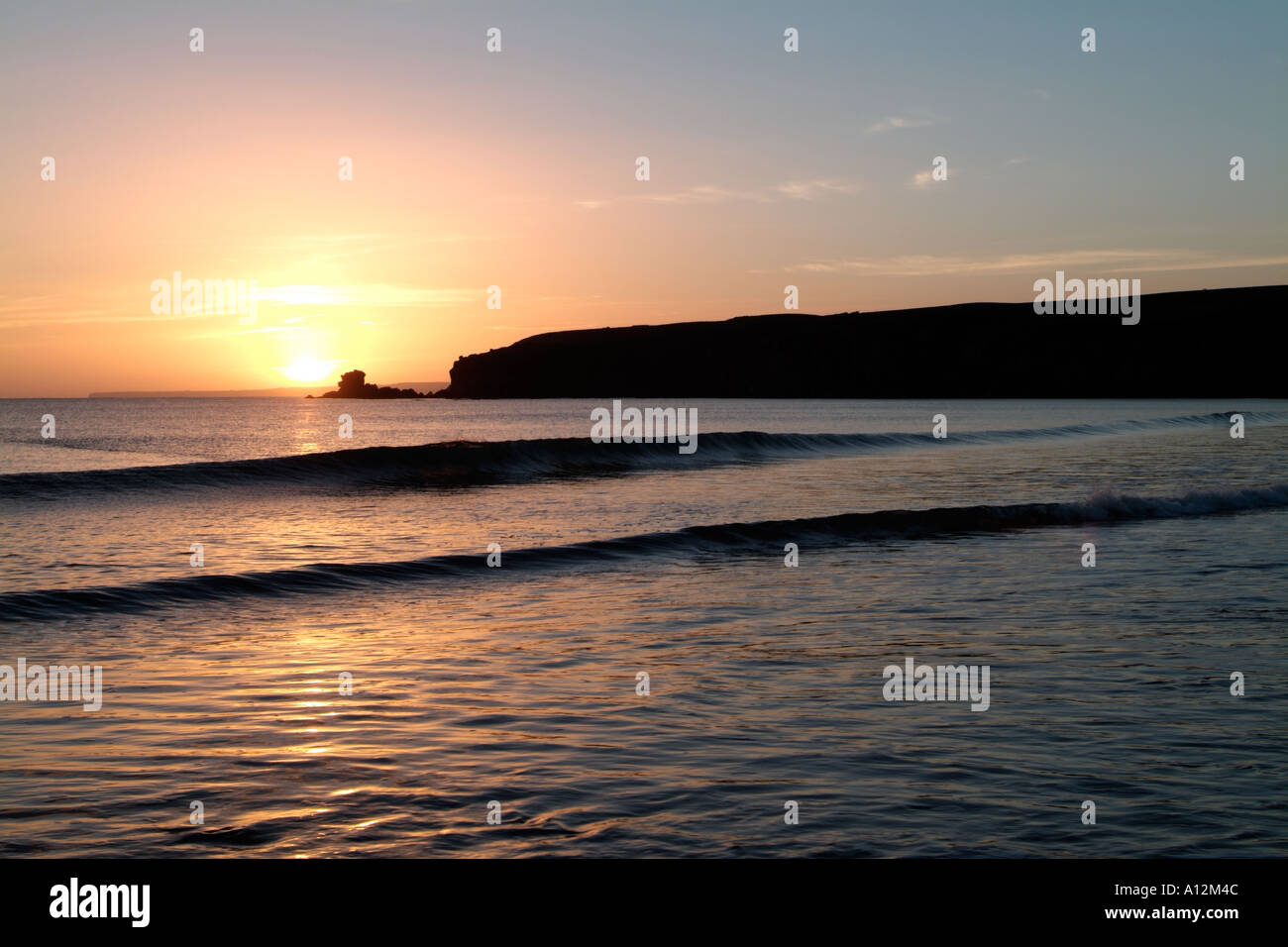 Wave cresting gently at sunset on Bunmahon Bonmahon beach County ...