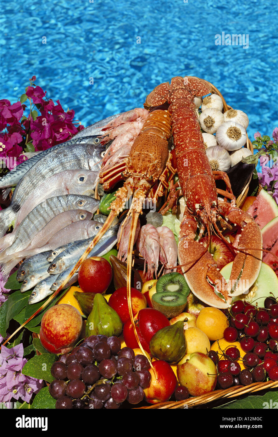 variety of fresh fish lobster and crayfish with fruit by swimming pool ...