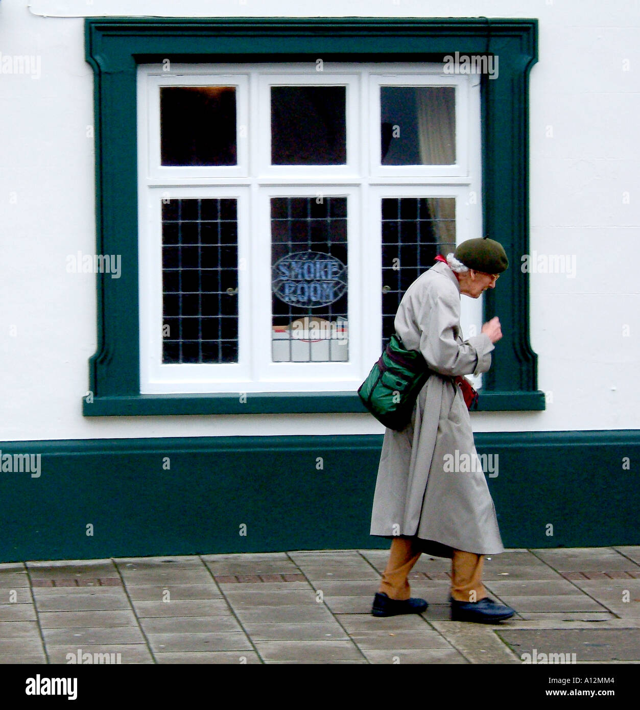 old woman walking past pub window Stock Photo - Alamy