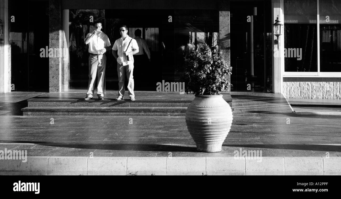 two men standing waiting Stock Photo - Alamy