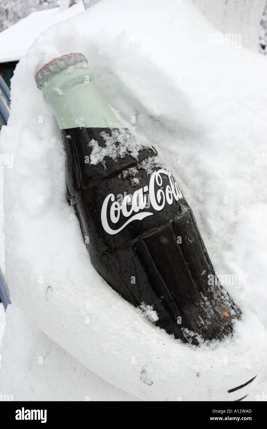 big coca Cola bottle in the snow in front of a bar Stock Photo - Alamy