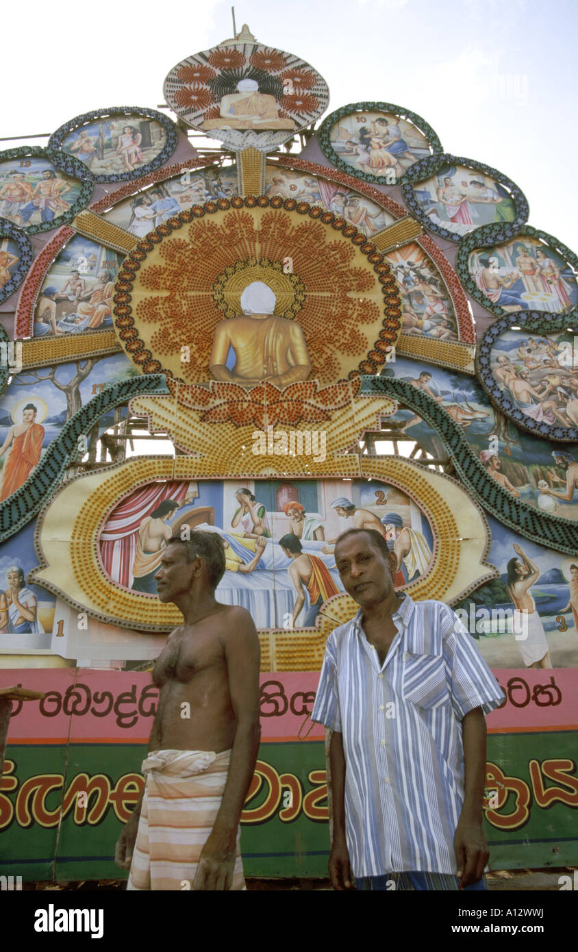 Two men pose in front of a Wesak display called a Pandol or Thorana in ...