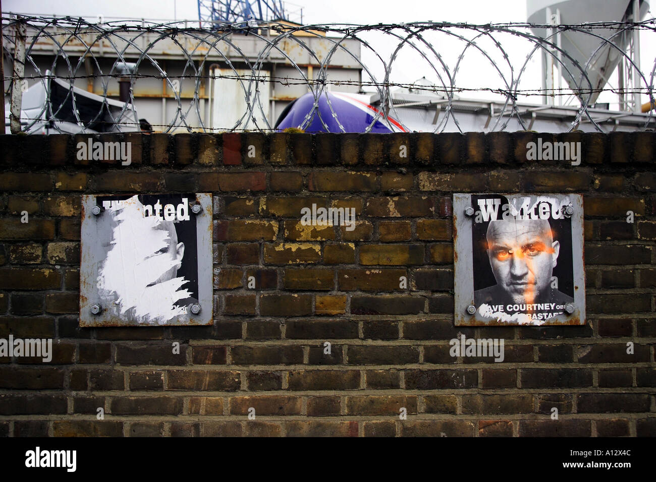 Brick wall barbed wire graffiti hi-res stock photography and images - Alamy