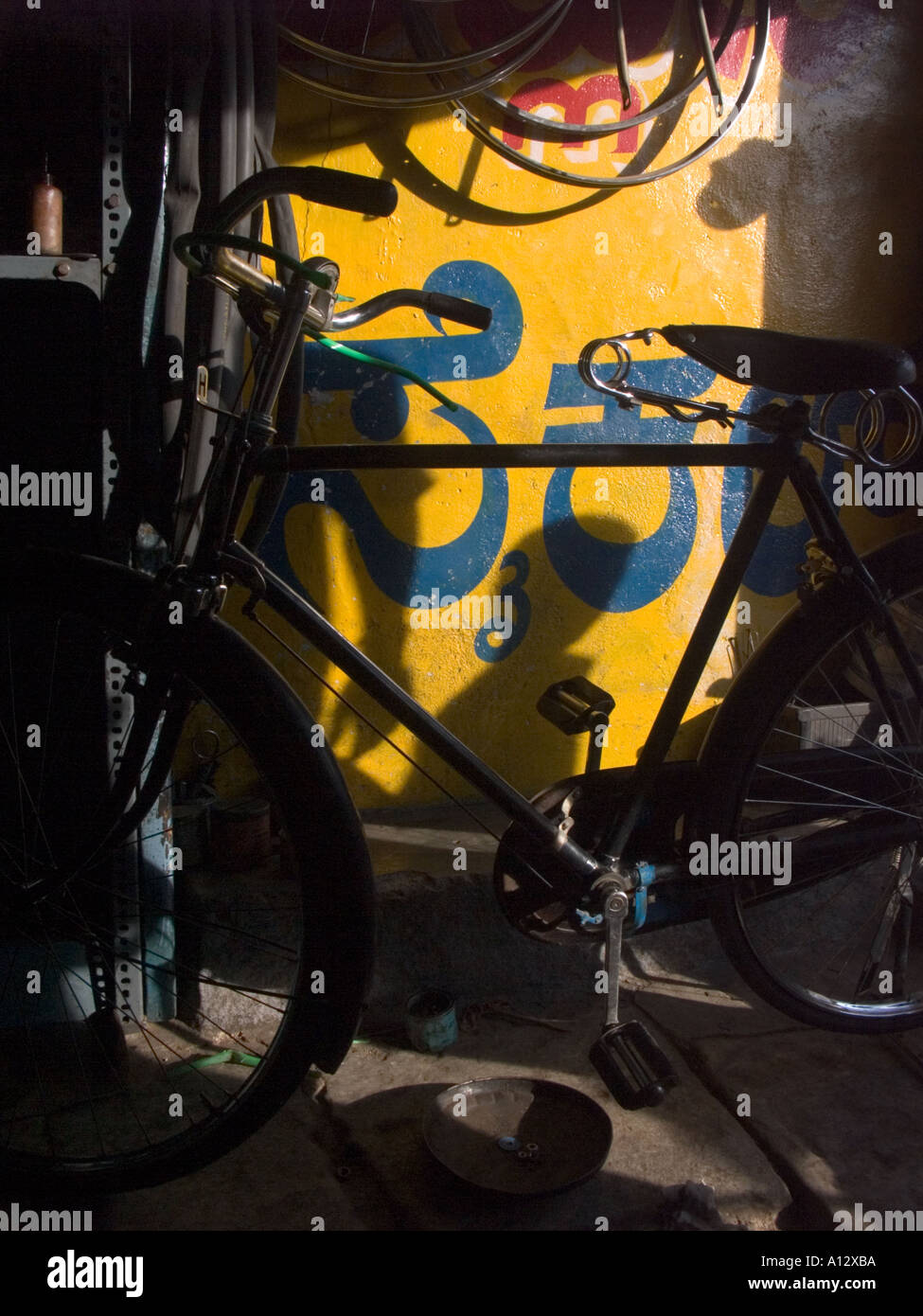 Shadow of a mechanic working on bicycles Stock Photo - Alamy