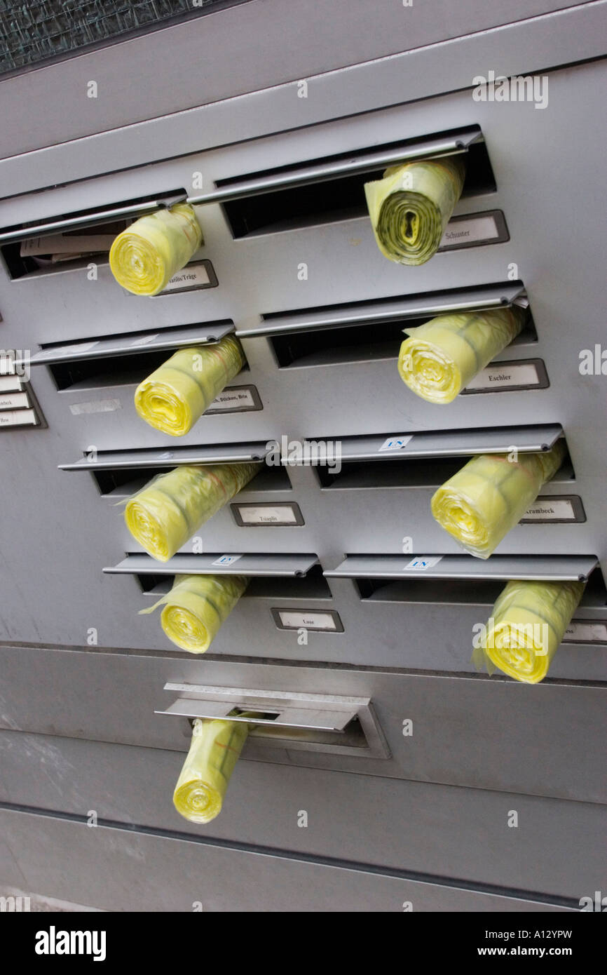 Nine Letter boxes with newspapers or advertising circulars wrapped in ...