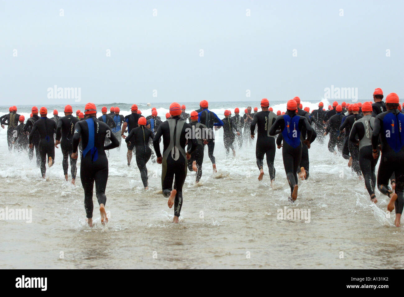 Competitors entering the sea at the start of the Perranporth Triathlon ...