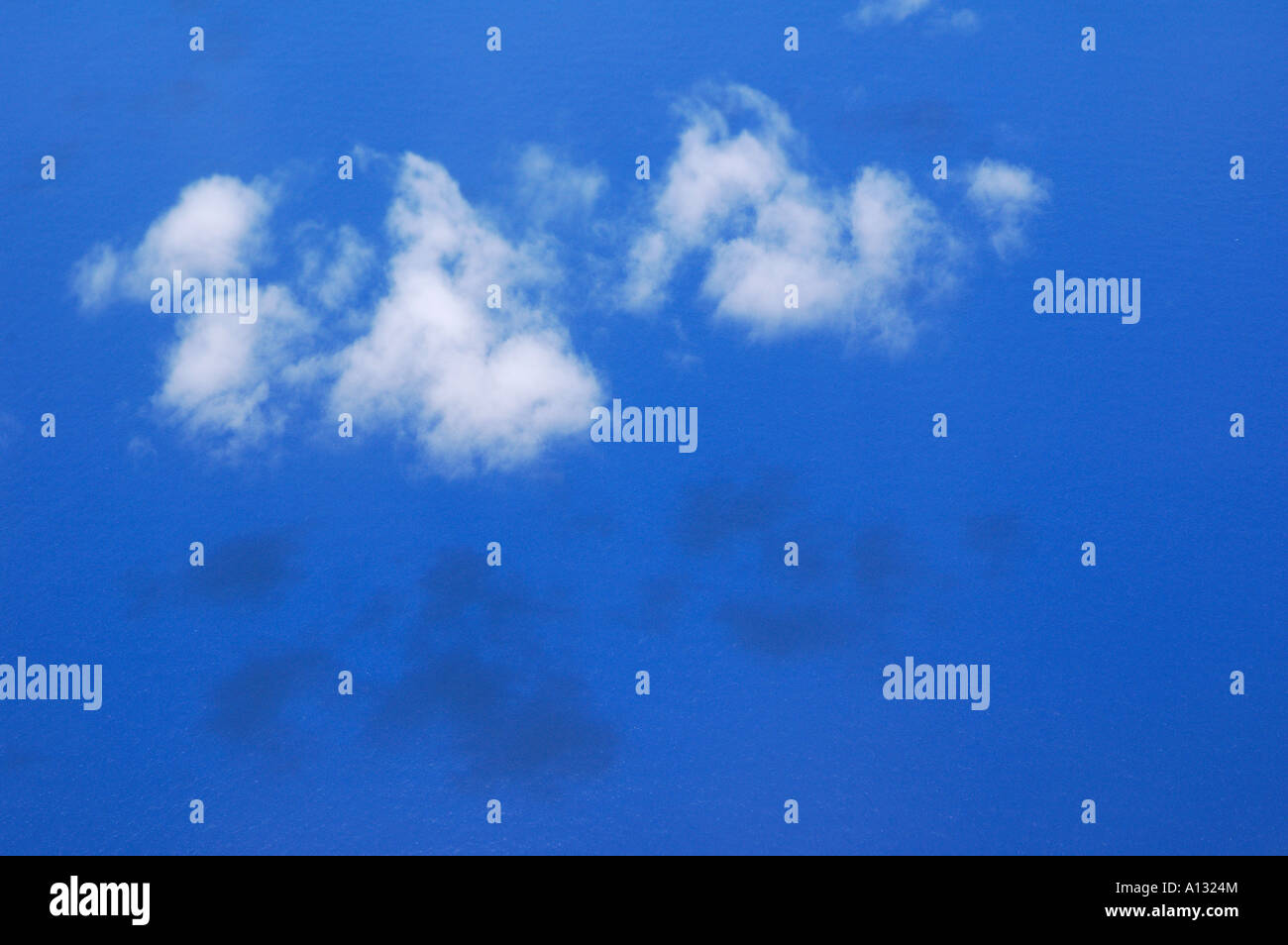 Clouds and their reflection over a azure tropical ocean Stock Photo - Alamy