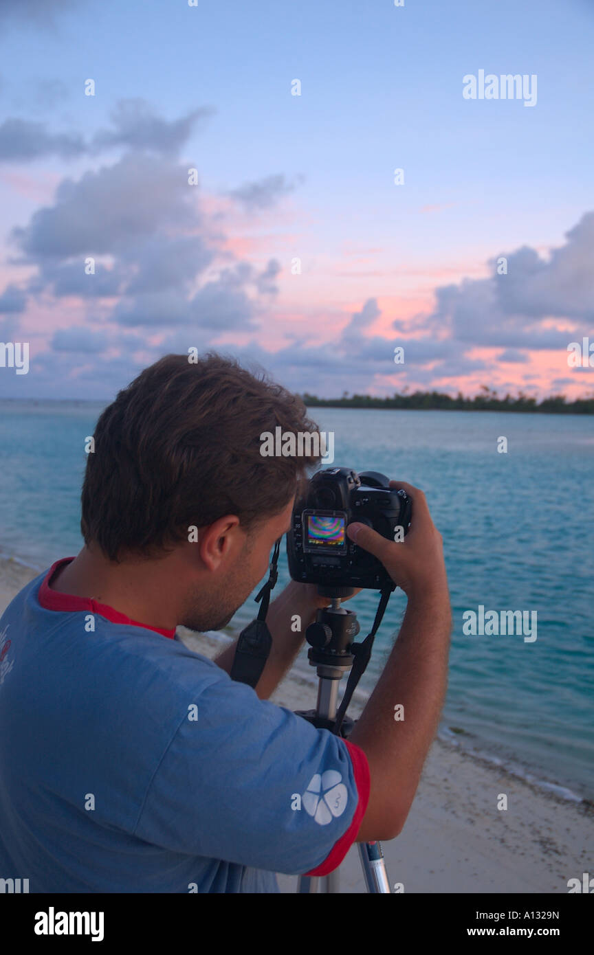 Photographer shooting a sunset Aitutaki lagoon Cook islands Stock Photo ...