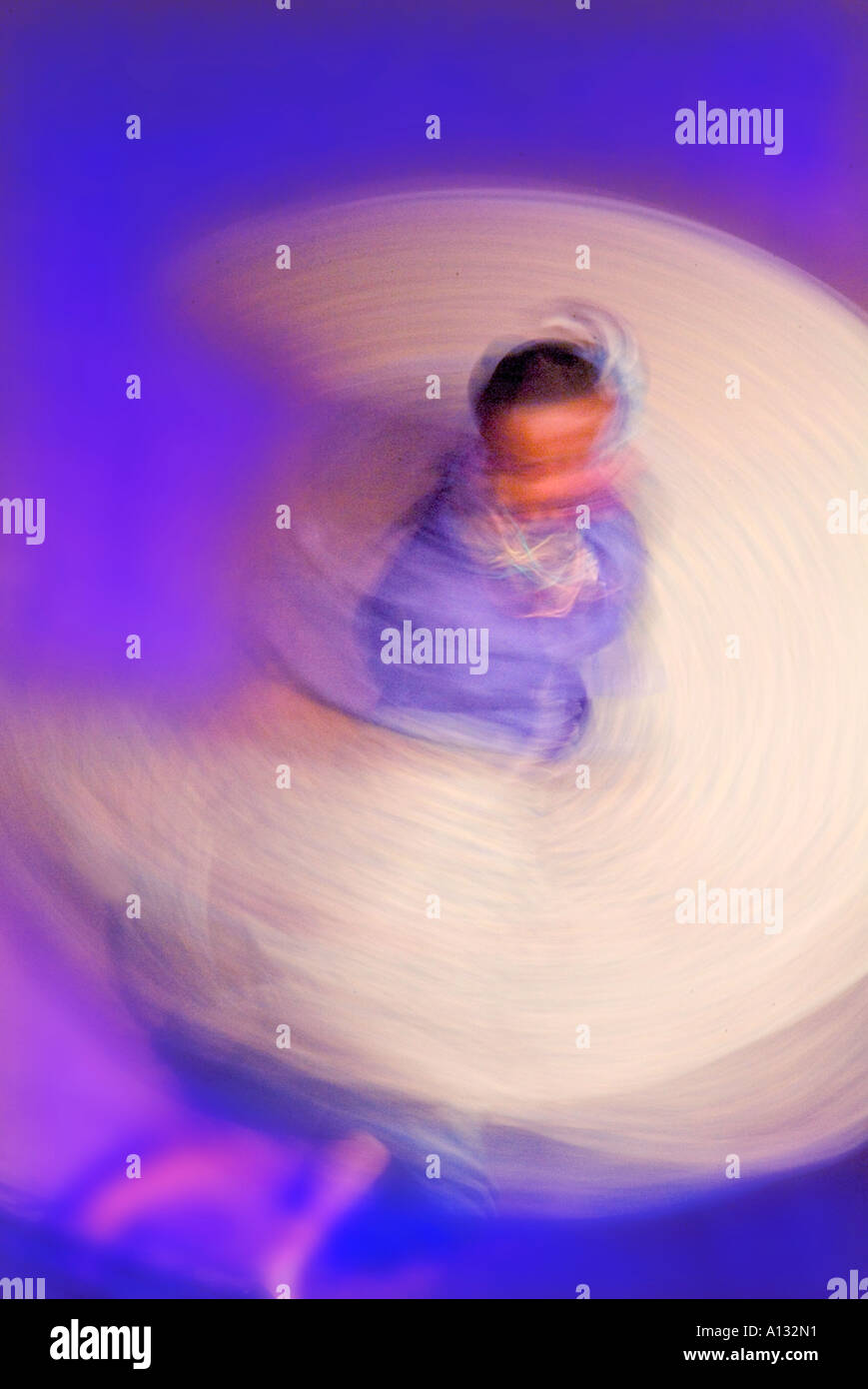 Dancer in blurred motion twirling long white skirt in a circular motion ...