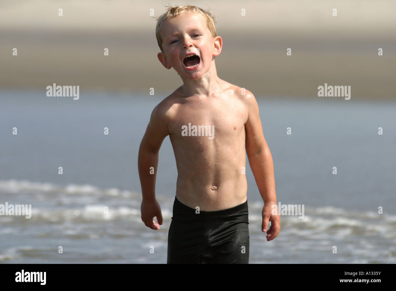 A boy yelling on the beach Stock Photo - Alamy
