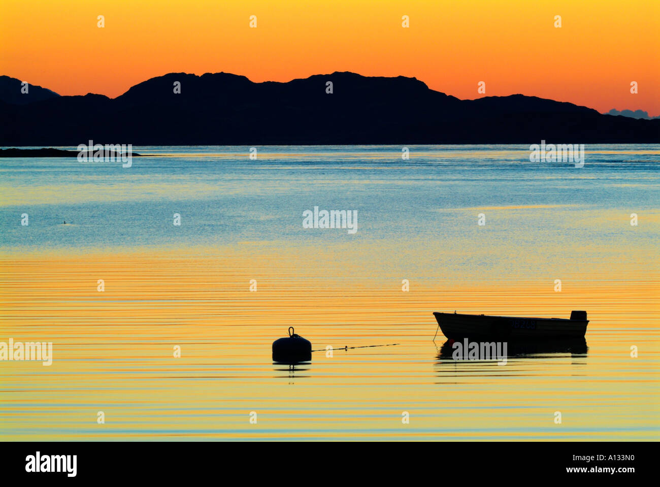 isolated boat tied upto mooring at sunset Stock Photo - Alamy