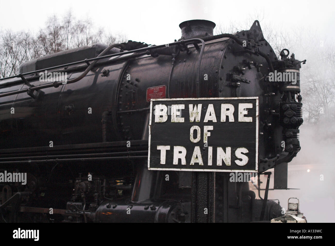 steam train with beware of trains sign Stock Photo - Alamy