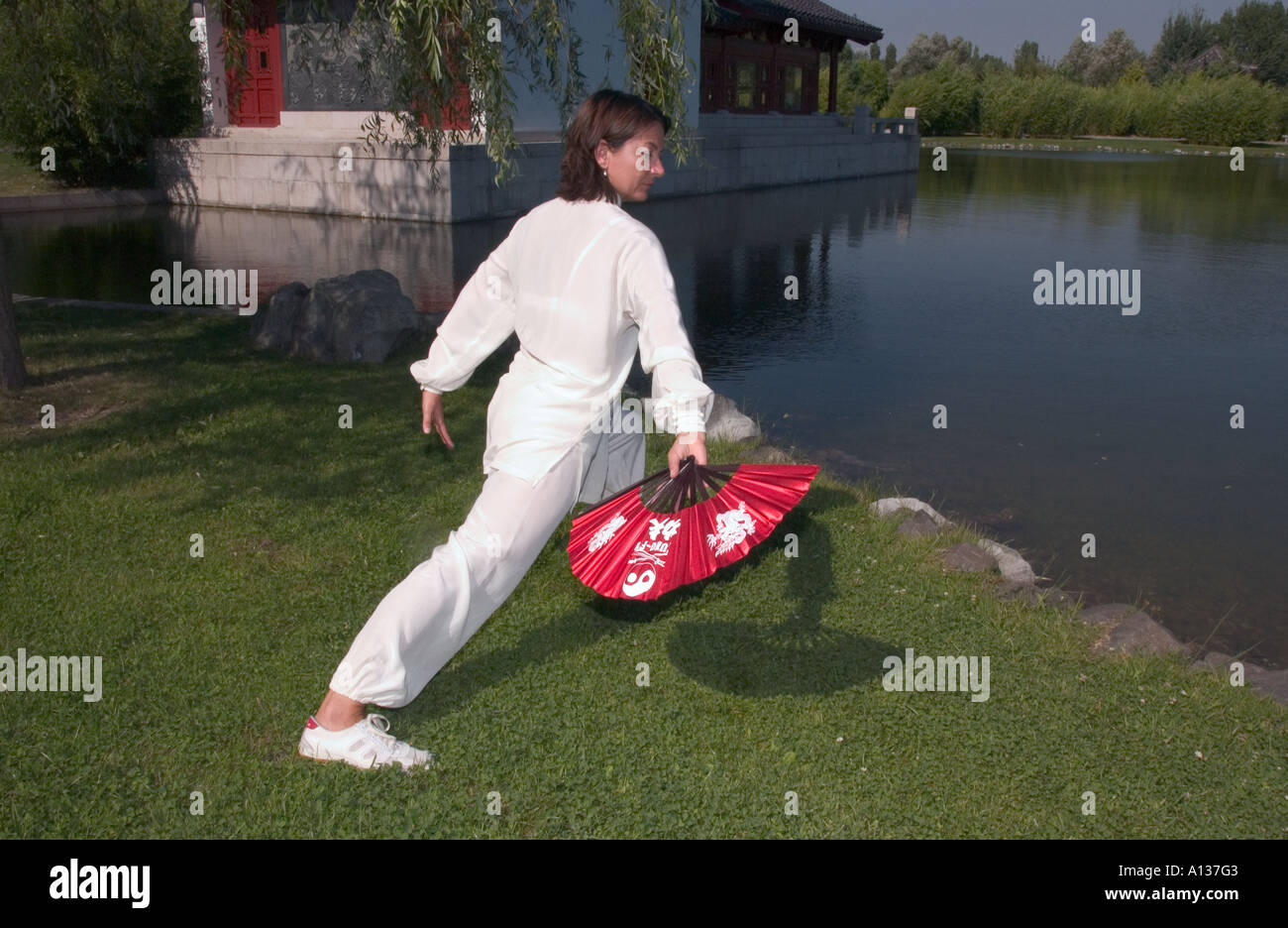 woman exercising tai chi in front of a chinese temple Stock Photo - Alamy