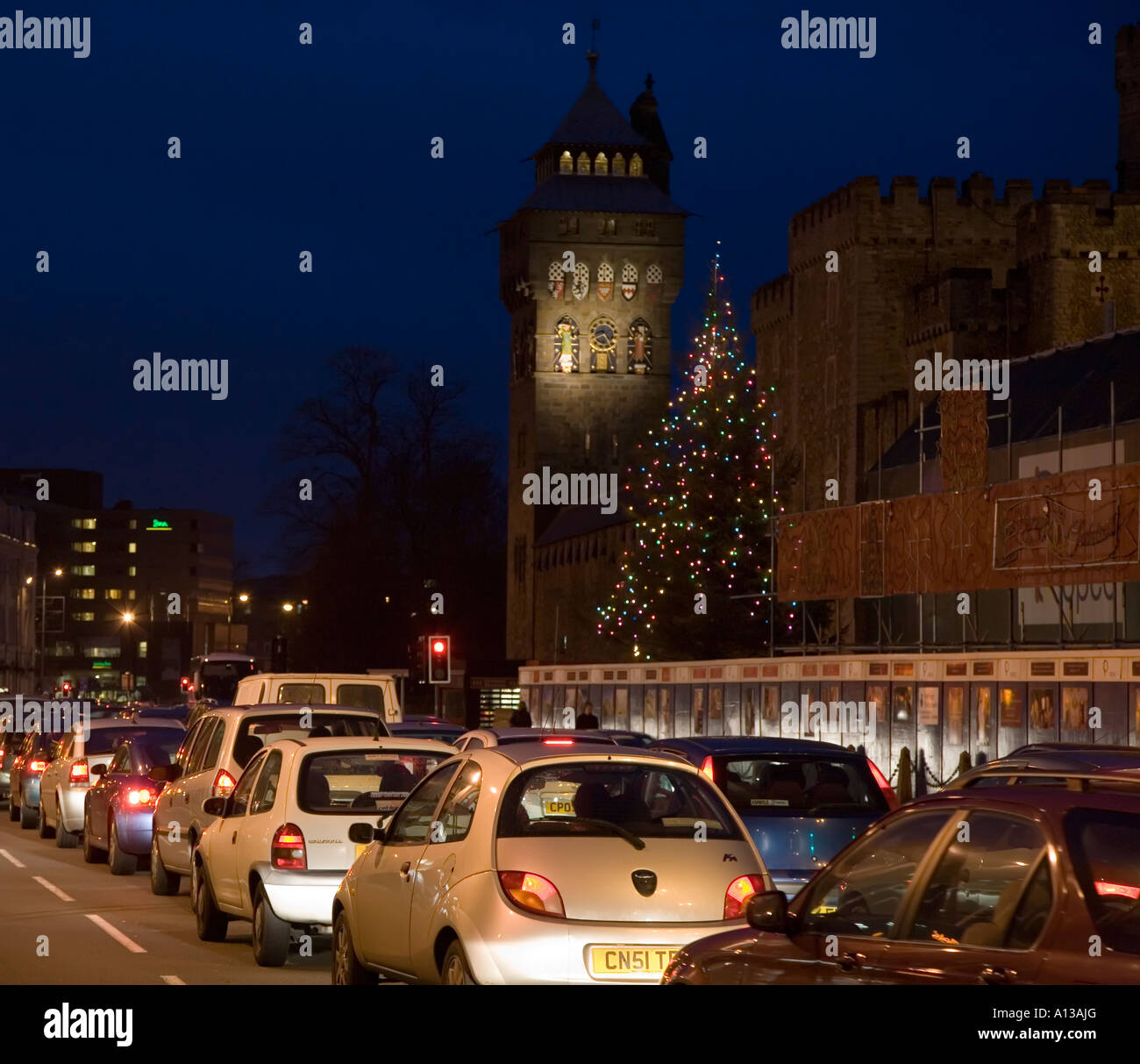 Traffic at rush hour at Christmas in front of castle Cardiff Wales UK ...