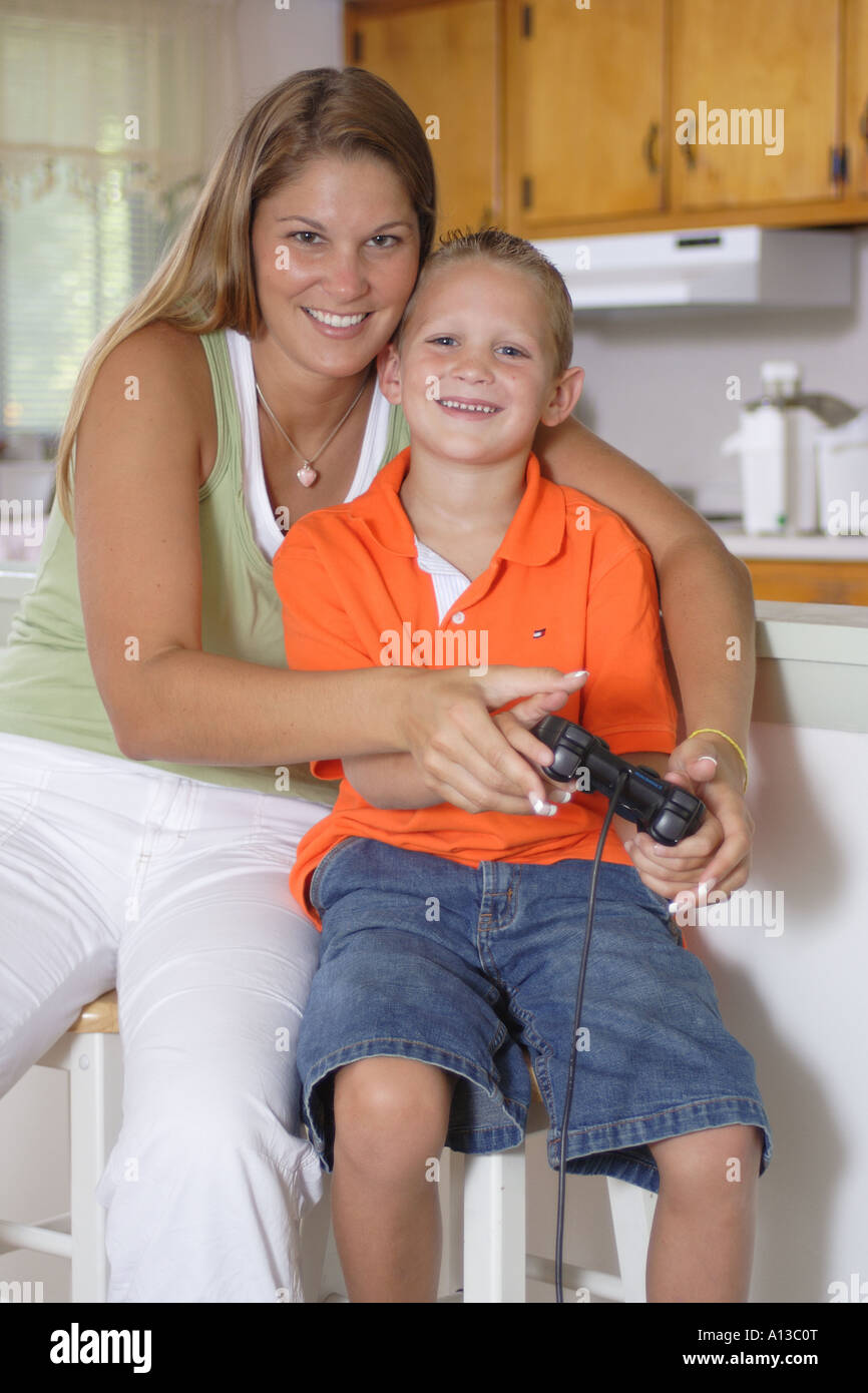 Mom and son having fun playing games Stock Photo - Alamy