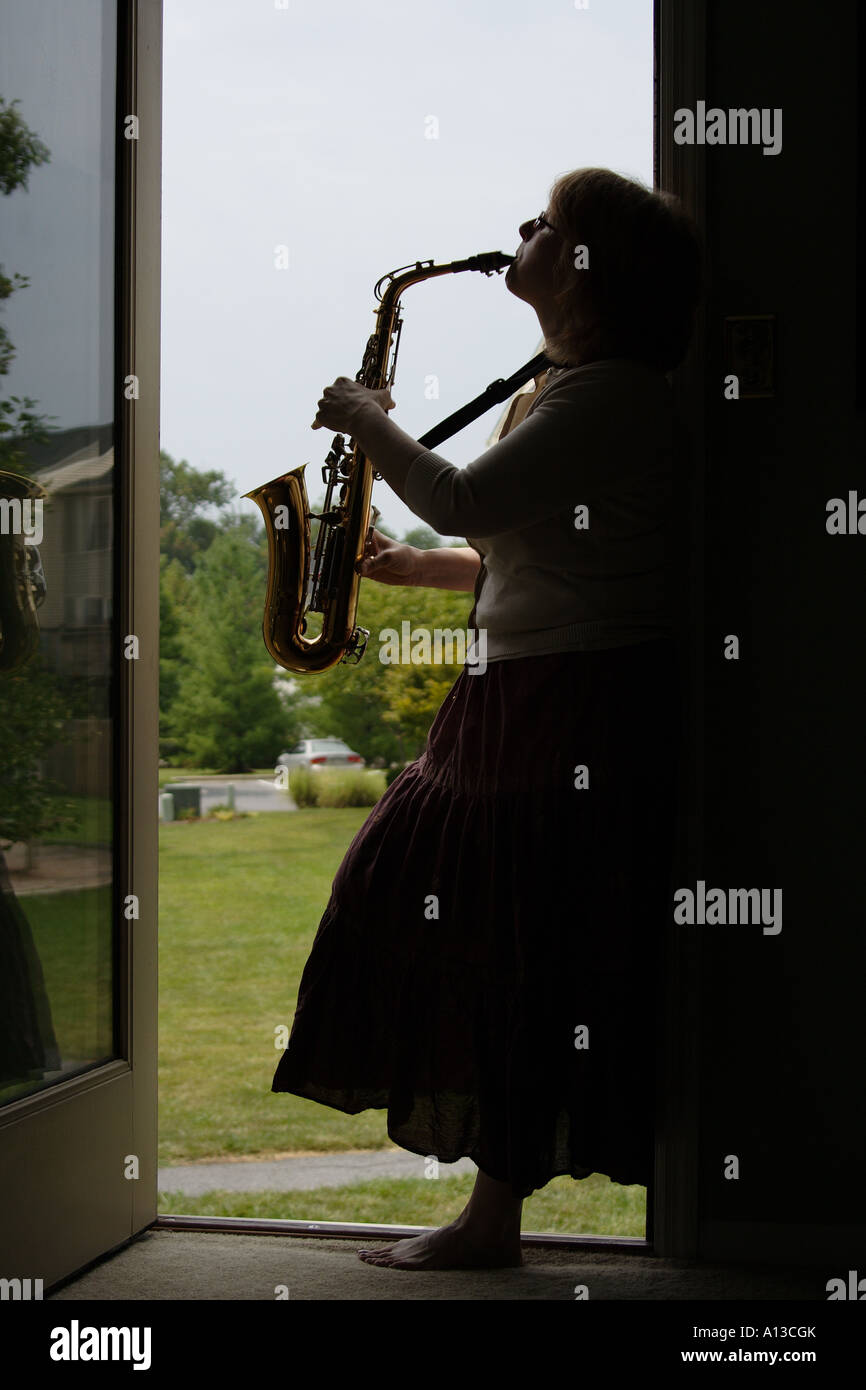 Middle aged Caucasian woman playing clarinet by the door Stock Photo ...