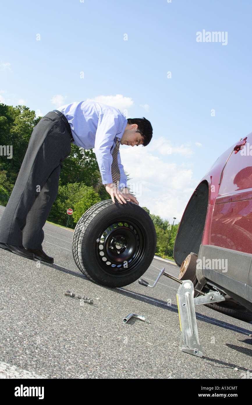 Asian man change a flat tire Stock Photo - Alamy