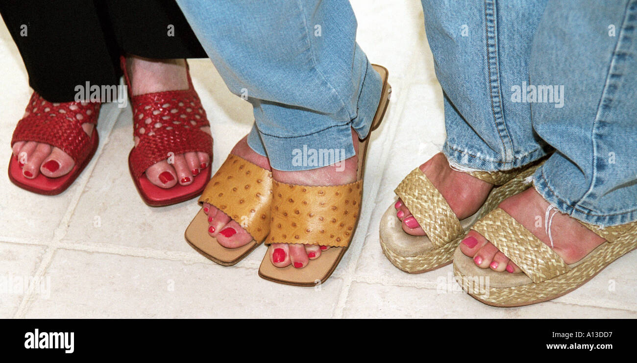 three pair of feet in open toes shoes with painted nails Stock Photo ...