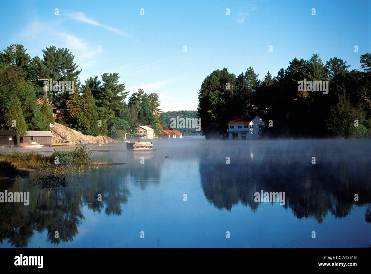 Red boathouse in morning mist Stock Photo - Alamy
