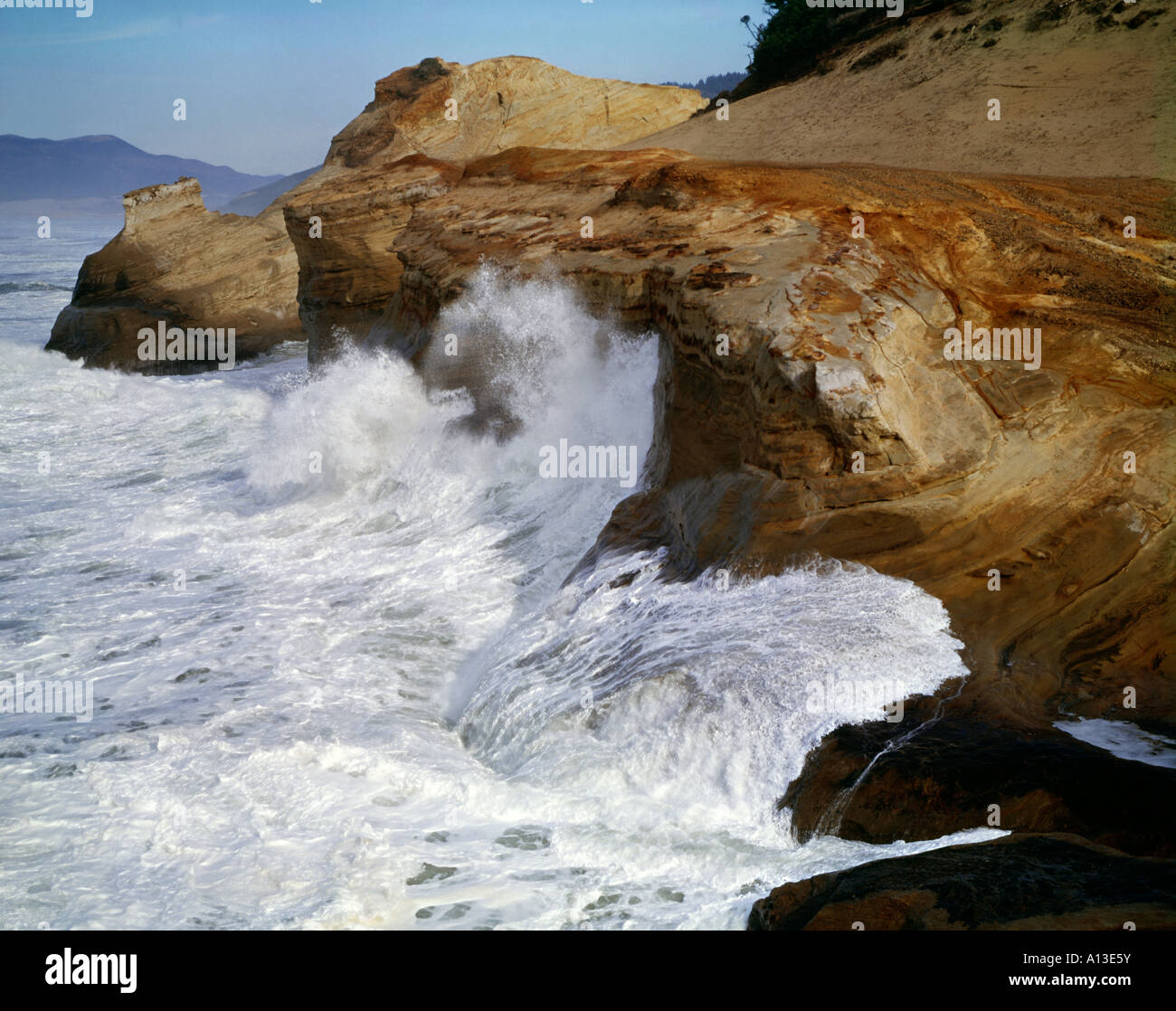 Huge Pacific Ocean waves crash onto the sandstone cliffs at Cape ...