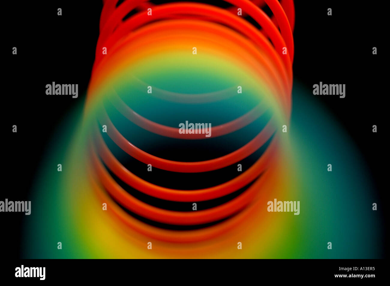 Slinky toy with black background Stock Photo - Alamy