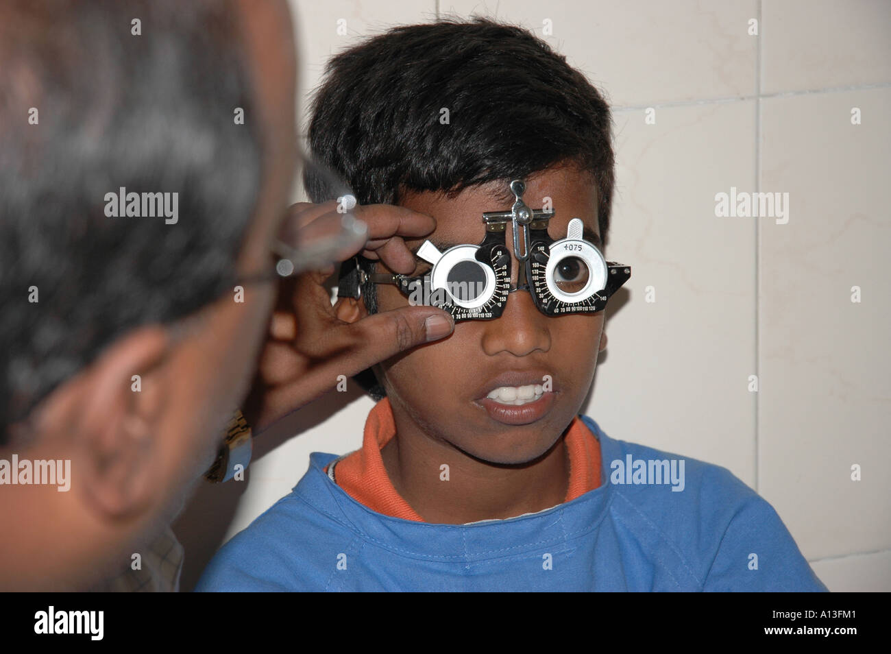 A young boy has a follow up eye test after a successful operation to ...