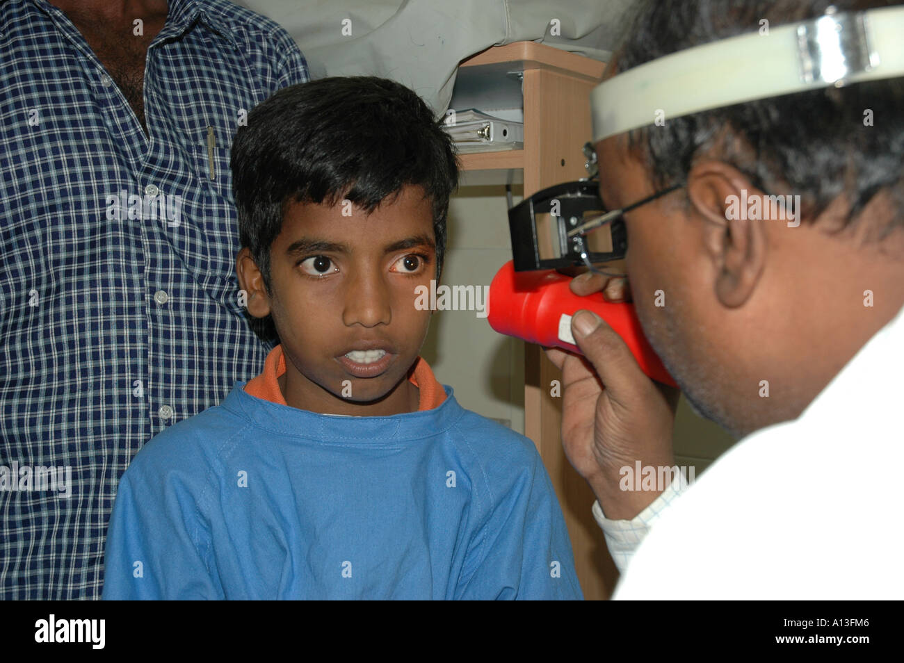 A young boy has a follow up eye test after a successful operation to ...