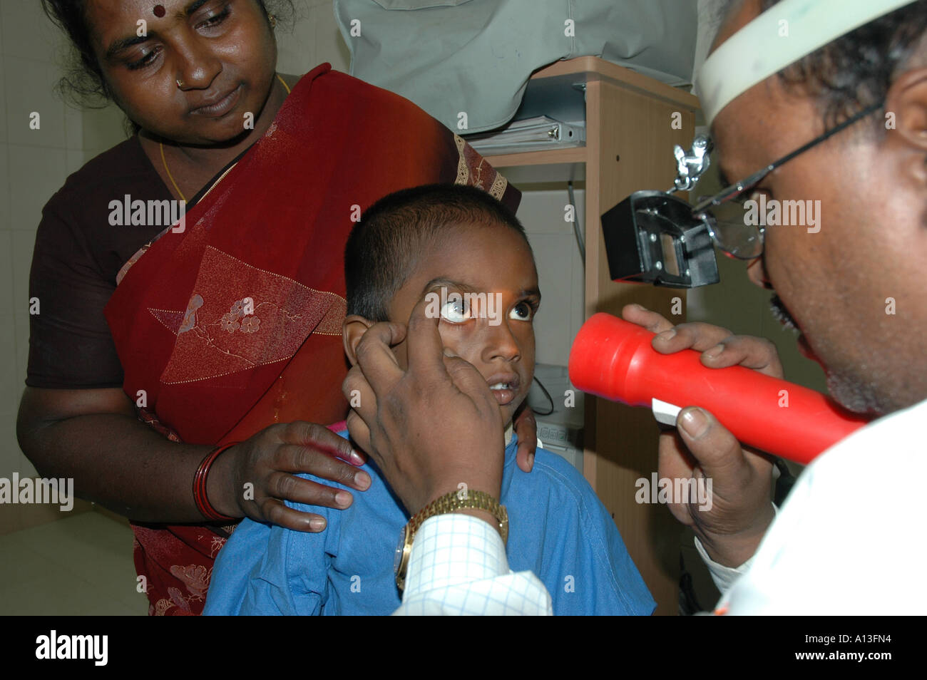 A young boy having a check up after successful cataract surgery in ...