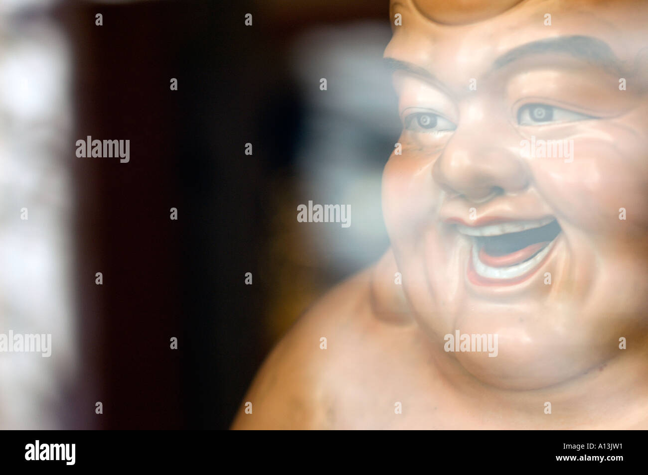 Buddha statue in the display window of a shop Stock Photo - Alamy