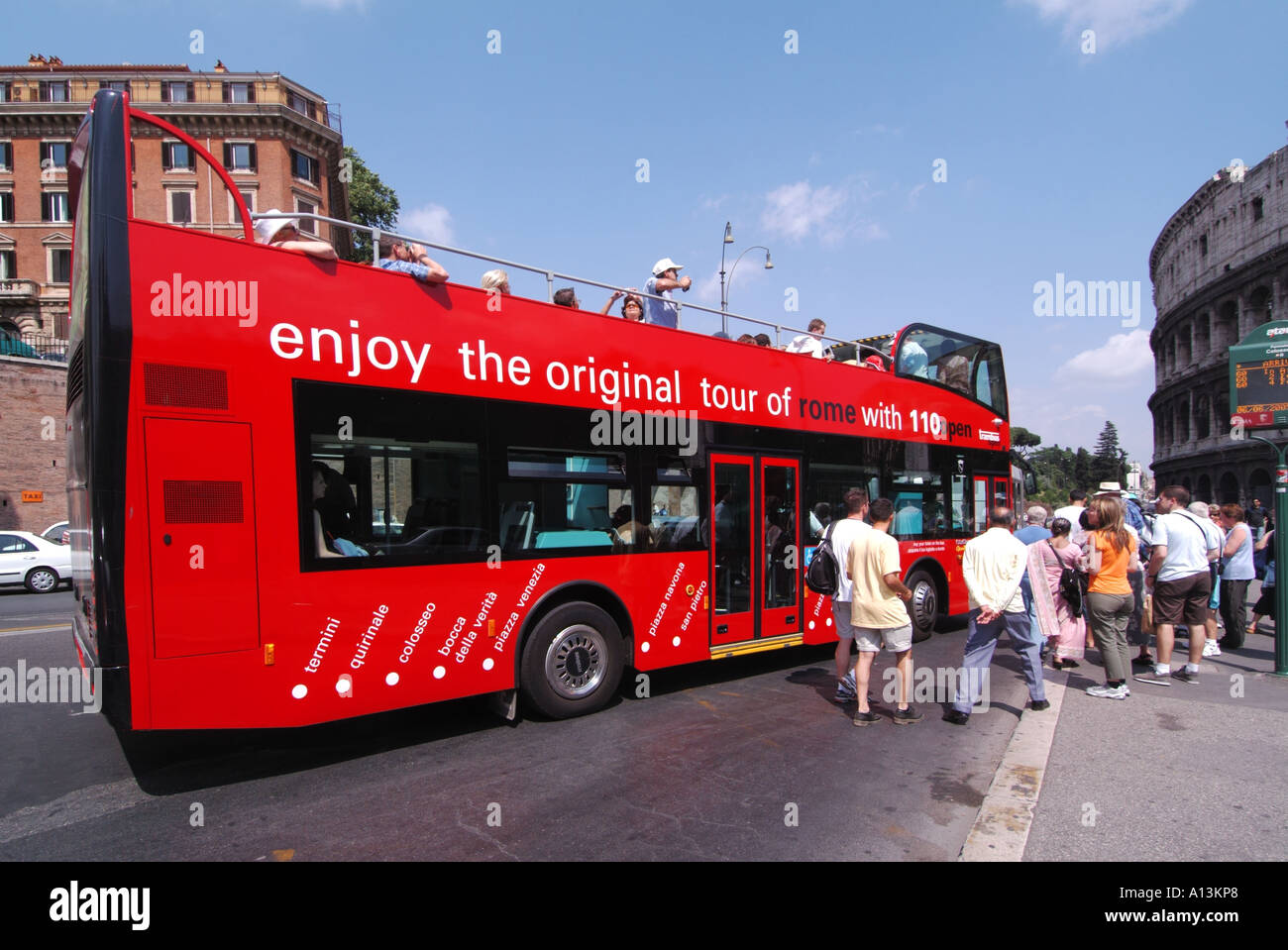 Tourists about to board red Stop & Go double decker open top tour bus ...