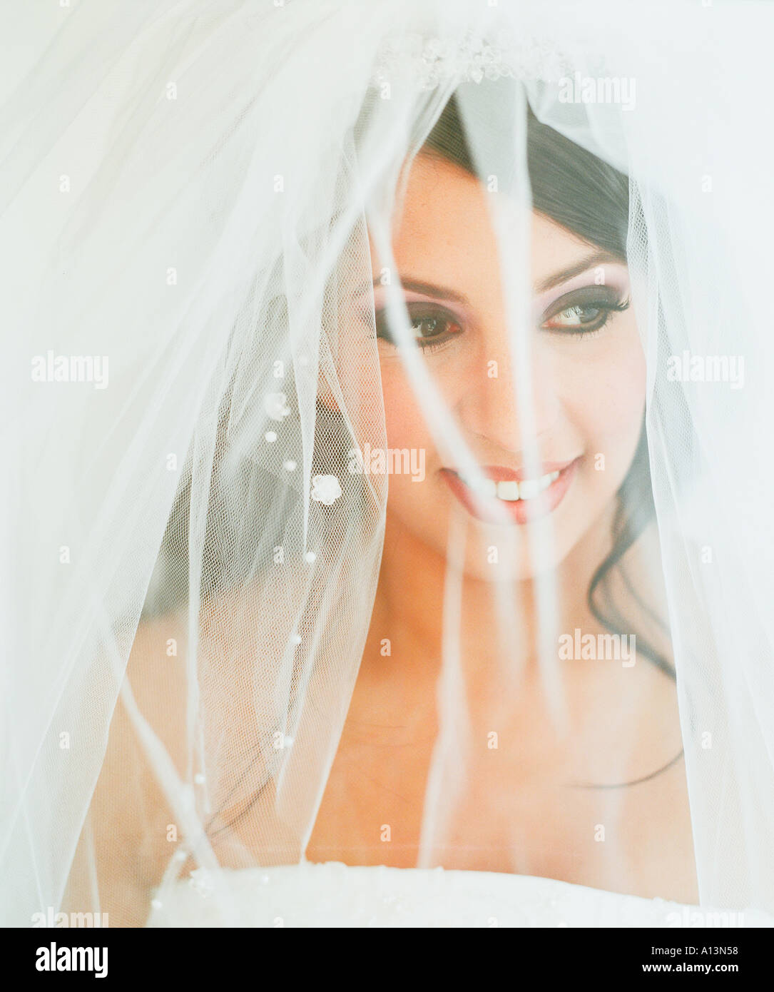 Young bride posing with veiled face Stock Photo - Alamy