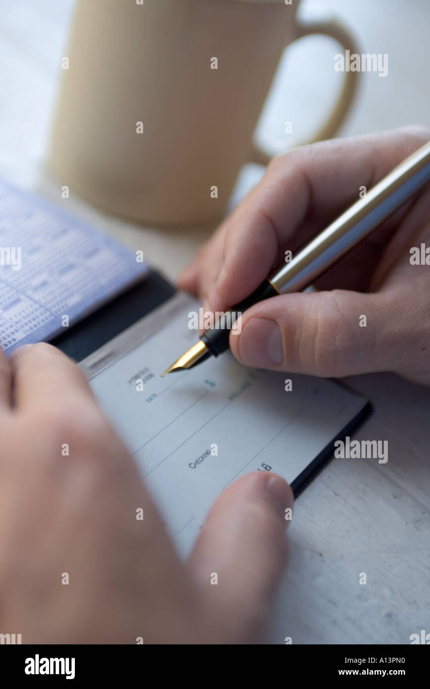 Writing a check Stock Photo - Alamy