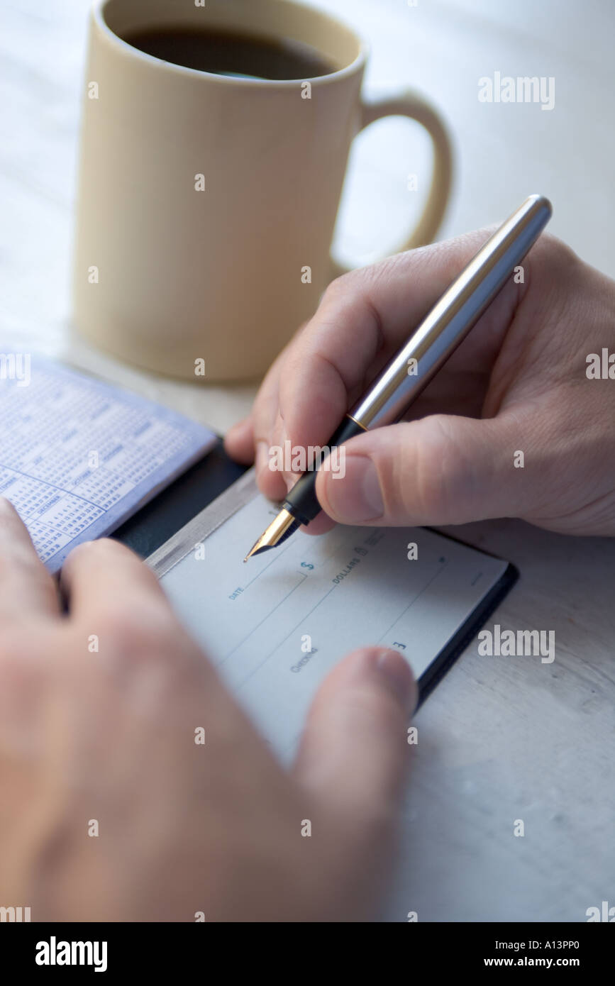 Writing a check Stock Photo - Alamy