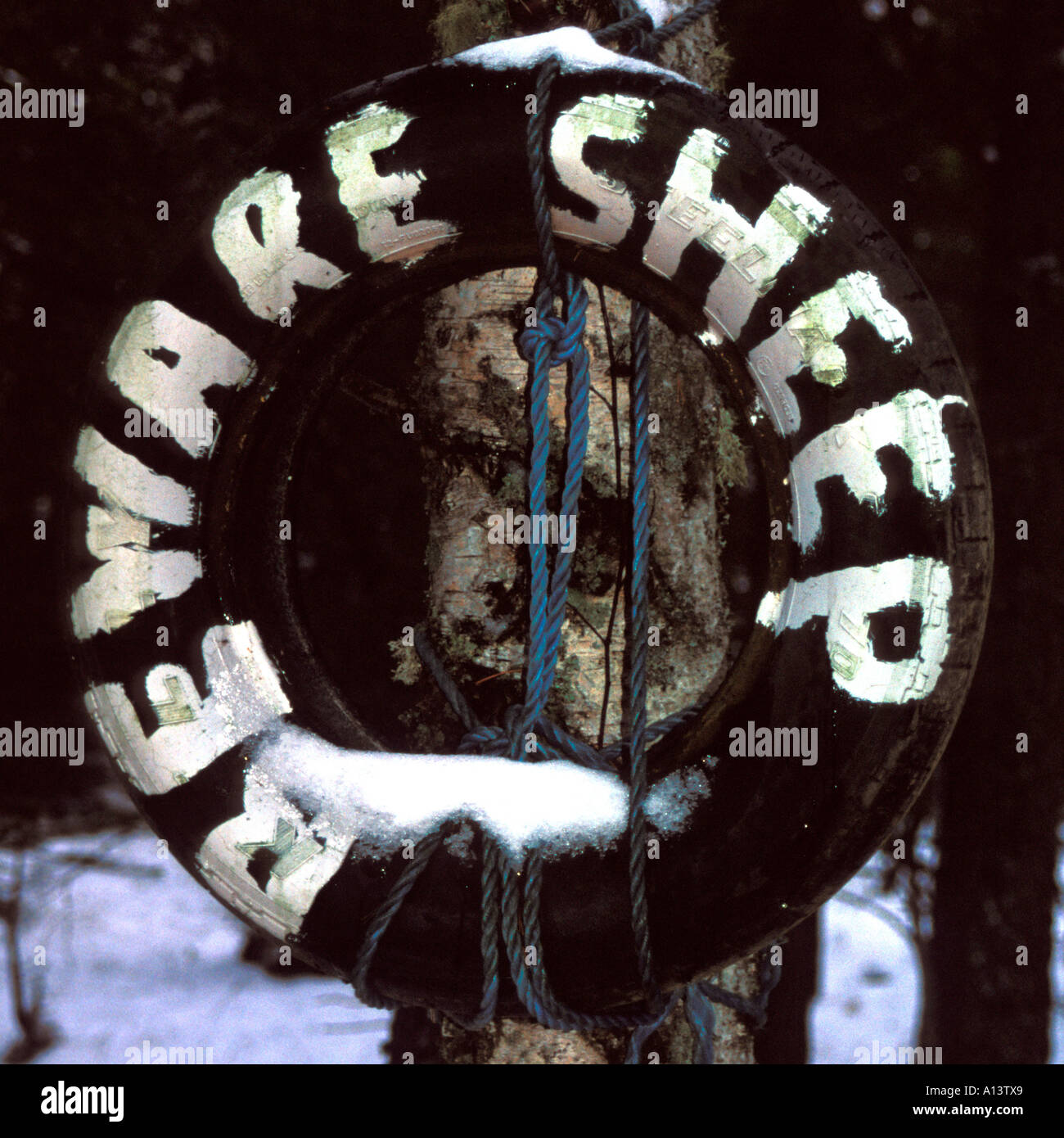 A black rubber tyre with the warning 'beware sheep' written in white ...