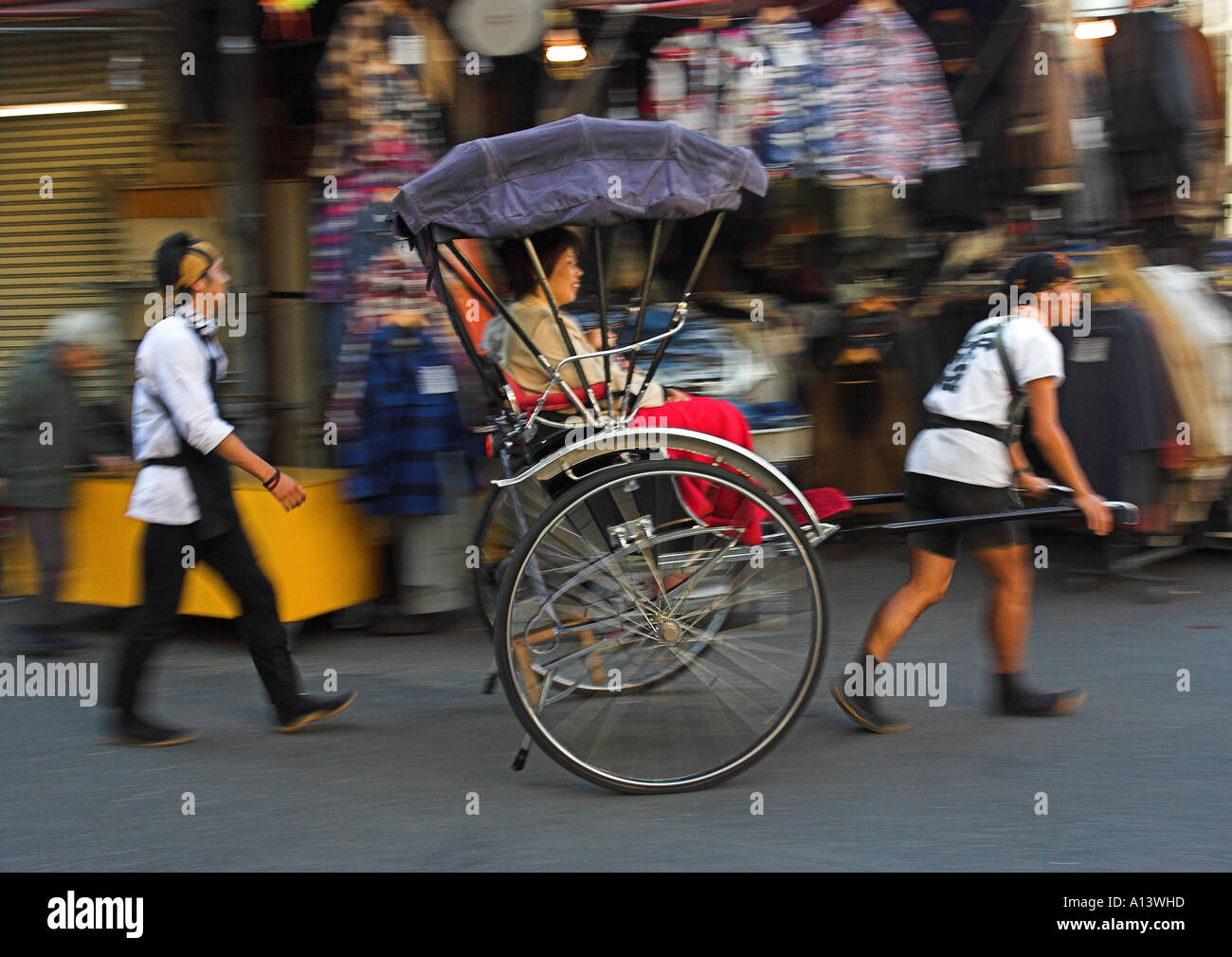 Tokyo street image of a japanese man pulling a carriage with single ...