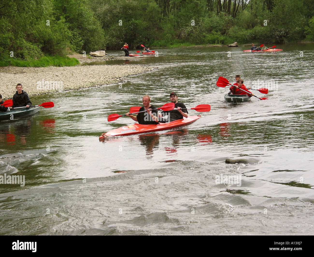 teenage school children canoeing on shallow river Stock Photo - Alamy