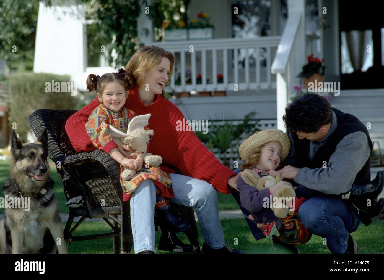 lifestyle outdoor portrait of a family at home in the backyard playing ...