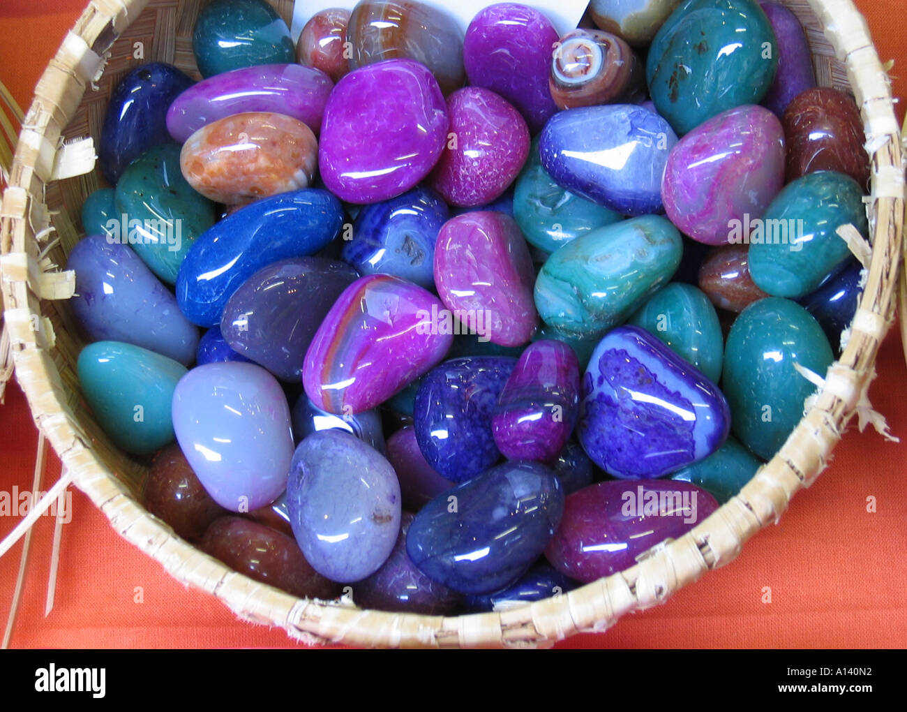 smooth glossy pebbles on display in basket Stock Photo - Alamy