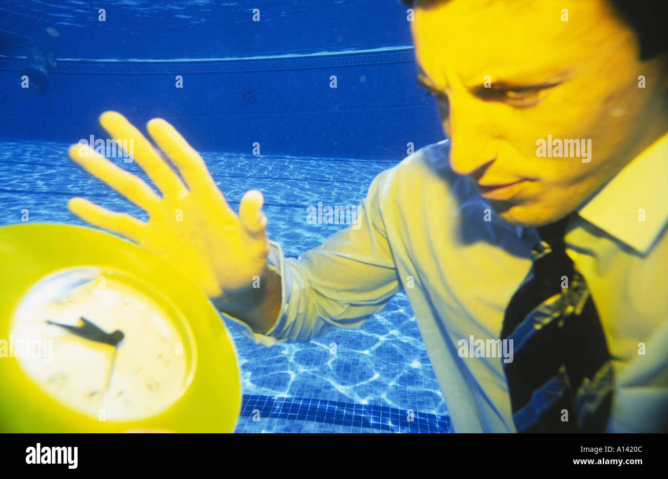 BUSINESSMAN CONTROLLING TIME CLOCK UNDERWATER ON A SWIMMING POOL Stock ...