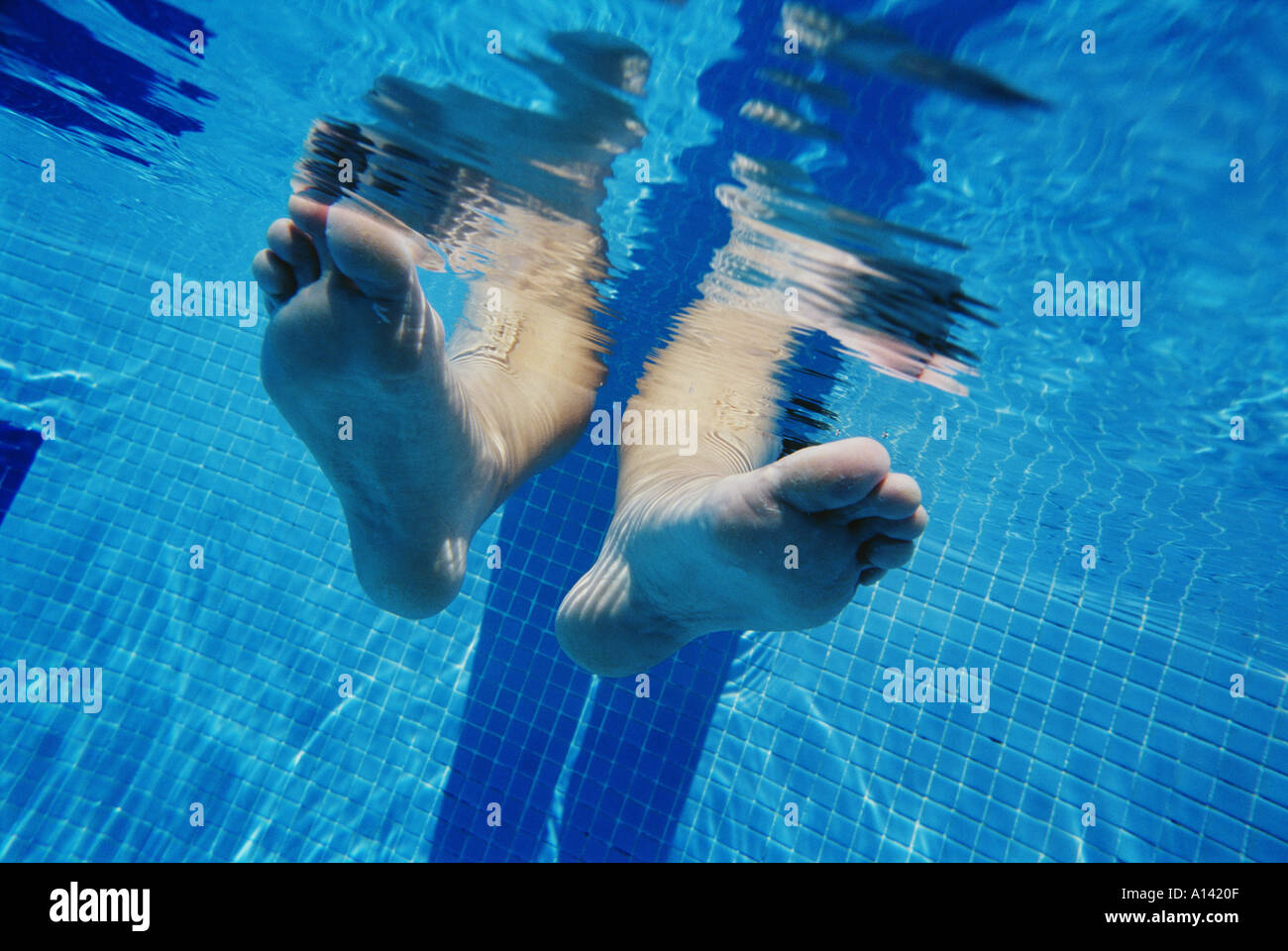 FEET UNDERWATER ON SWIMMING POOL Stock Photo - Alamy