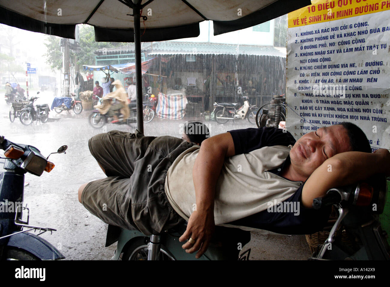 Man sleeping on his motorbike, Saigon (HCMC) Vietnam Stock Photo - Alamy