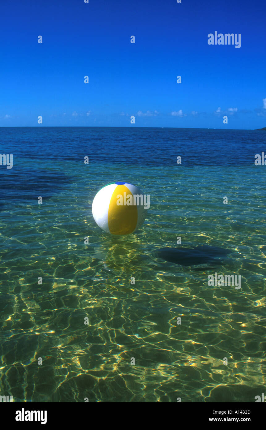 Beach ball floating on tropical waters Stock Photo - Alamy