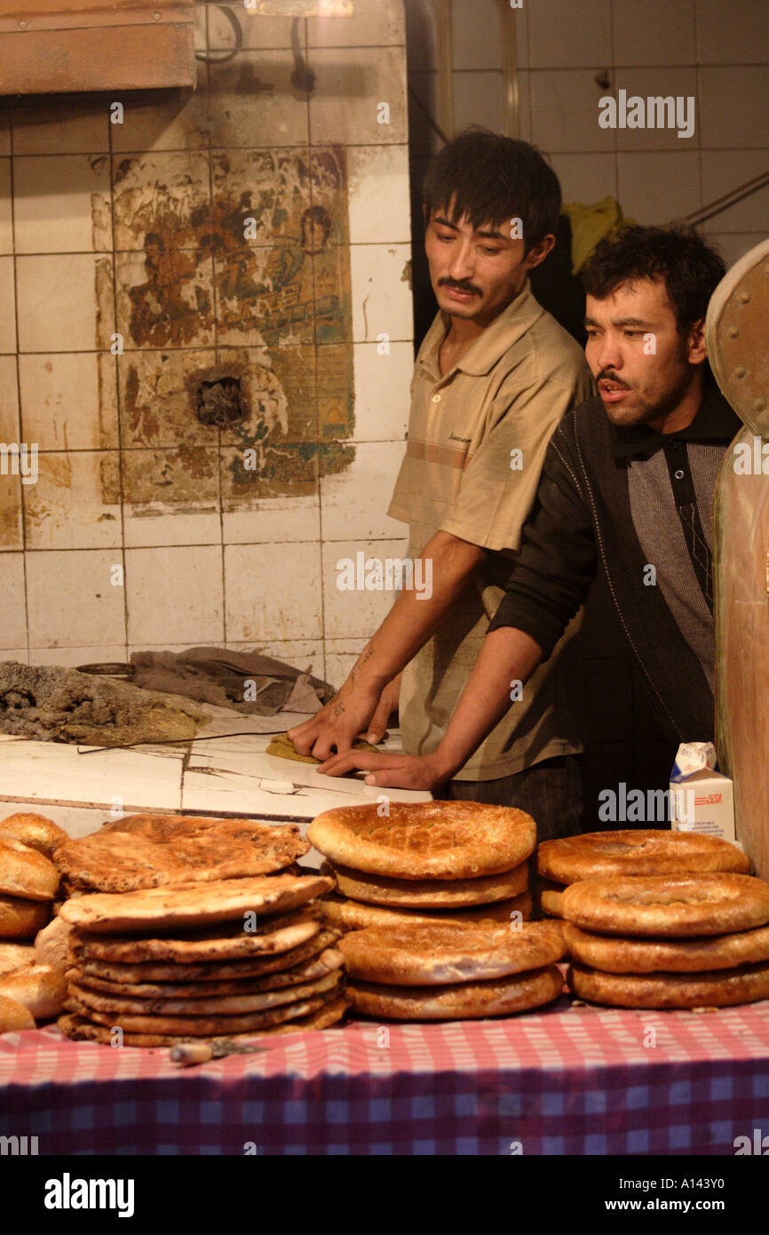 Men from western provinces of china making central asian bread in a ...