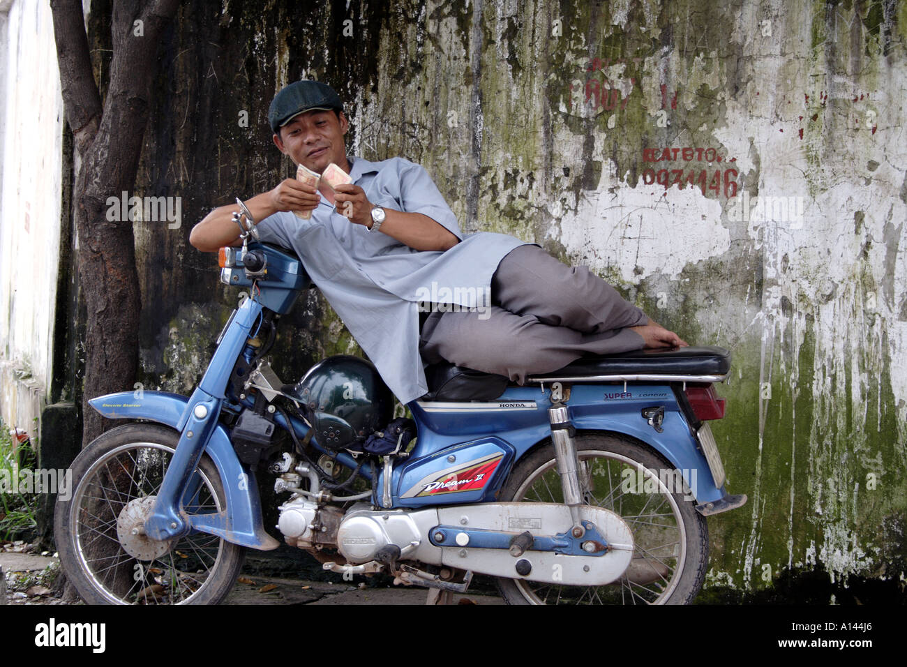 Motorbike Taxi driver counting his money, Saigon (HCMC), Vietnam Stock ...