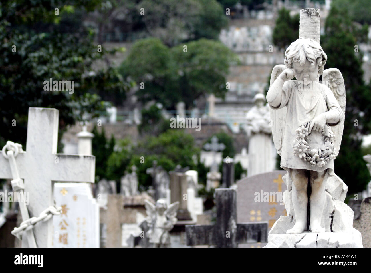 Monument of a crying angel in Hong Kong Cemetery Stock Photo - Alamy