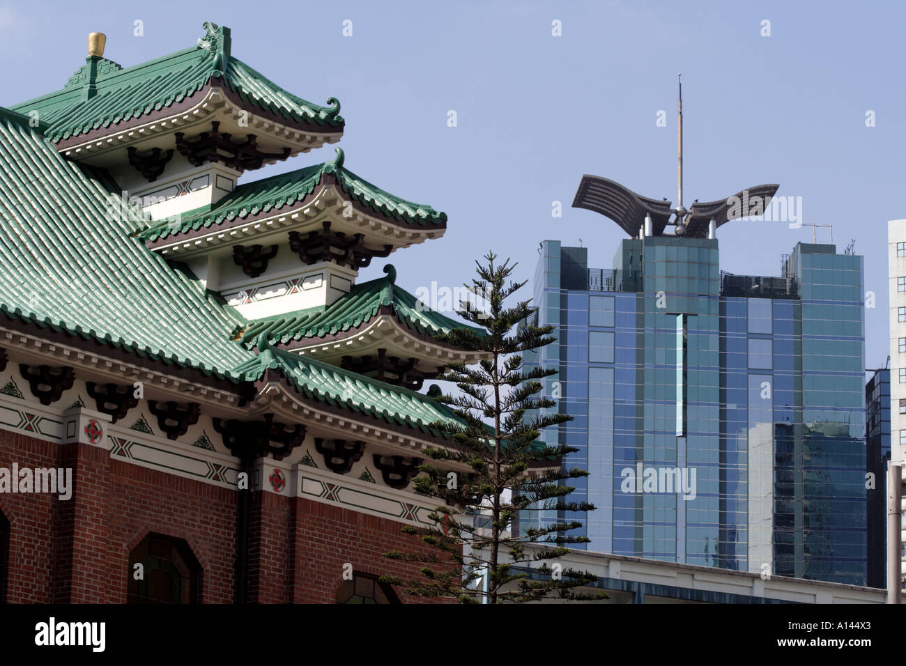 Christian Church (left) and modern skyscraper with asian influenced ...